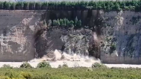 Watch: Dramatic footage shows cliff collapse into flooded river